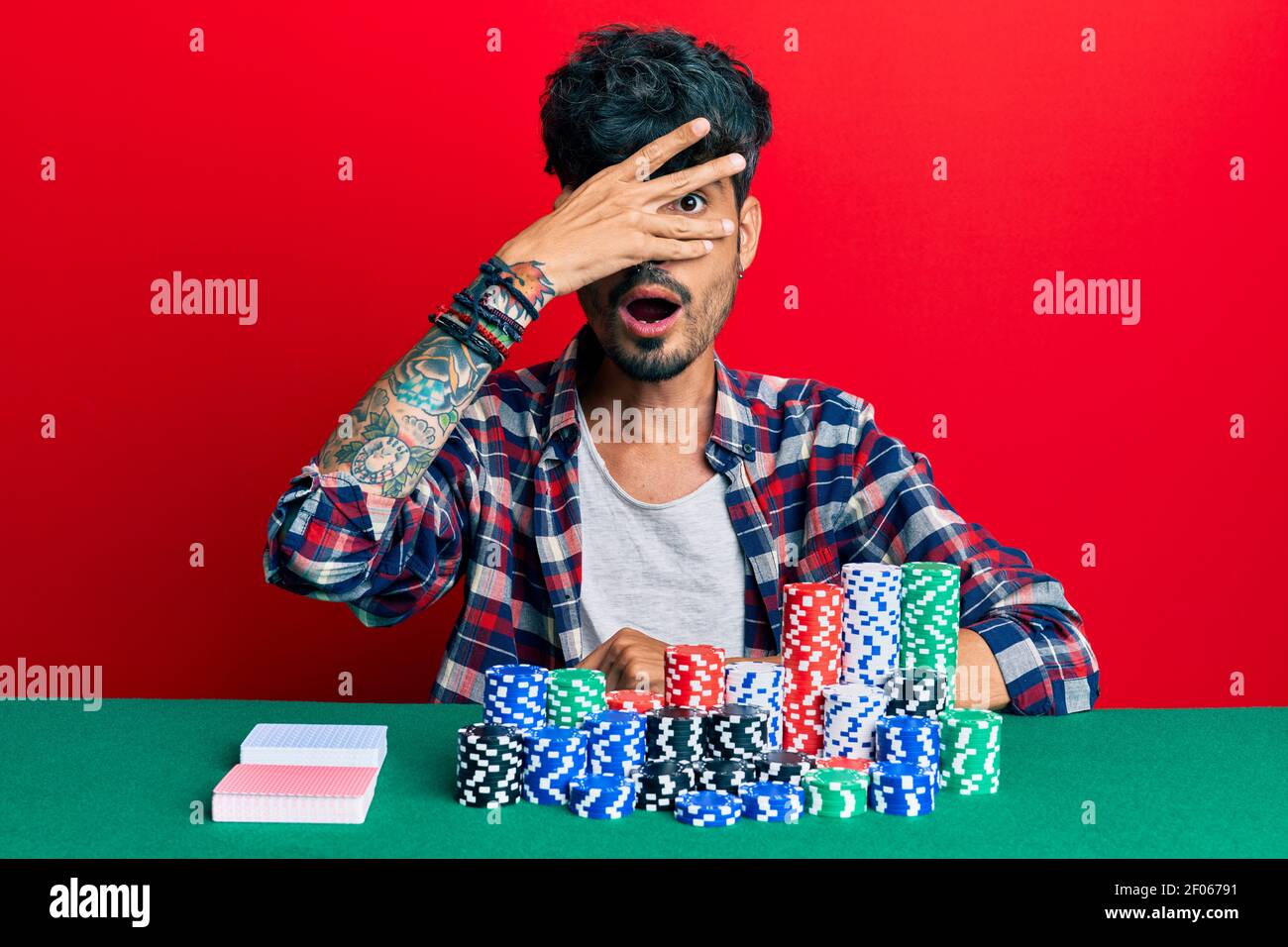 Hand on face looking at cards hi-res stock photography and images - Alamy