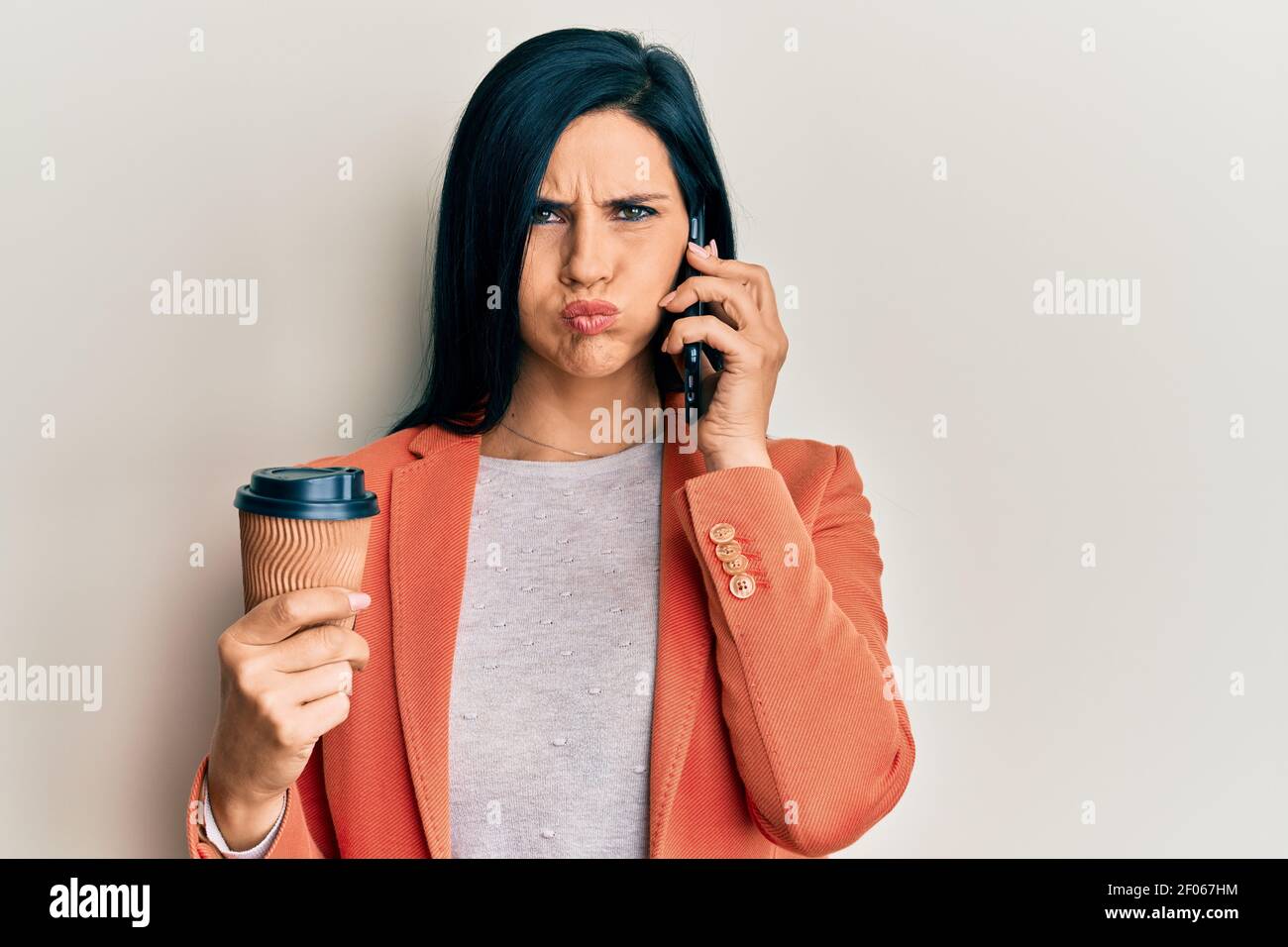 Young caucasian woman having conversation talking on the smartphone ...