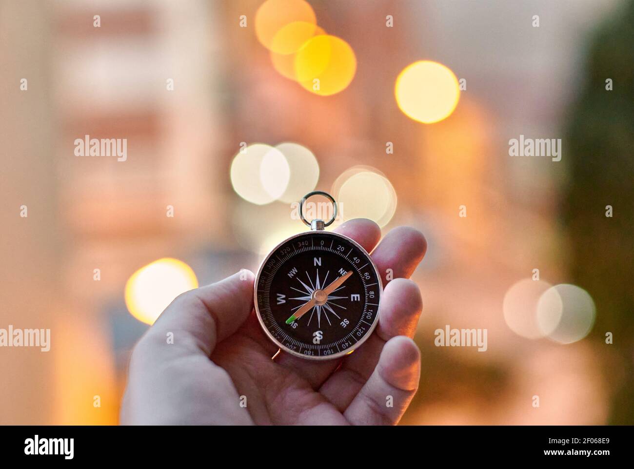 Closeup of hands holding a compass Stock Photo - Alamy