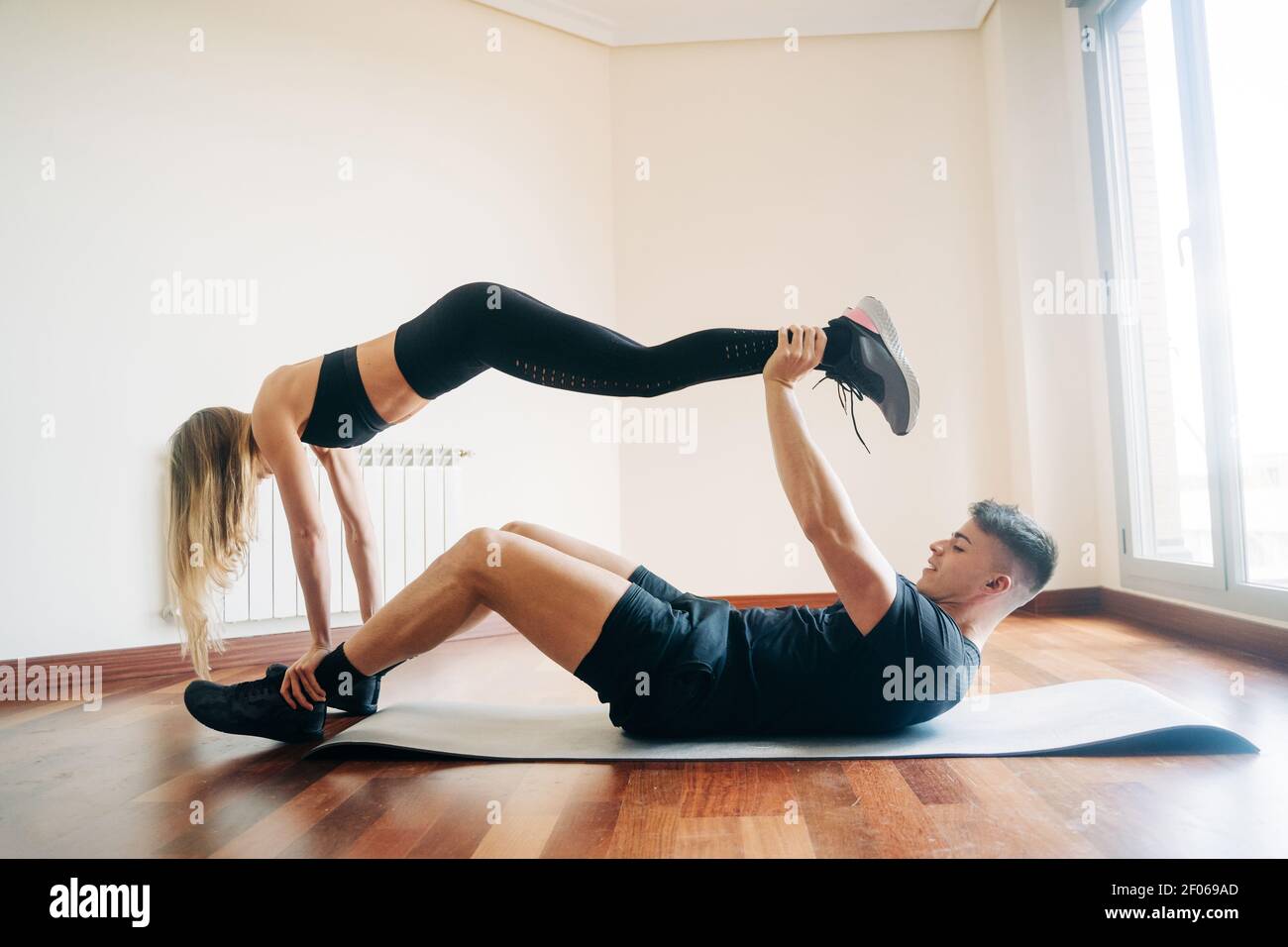Strong acrobatic woman lifting man hi-res stock photography and images ...