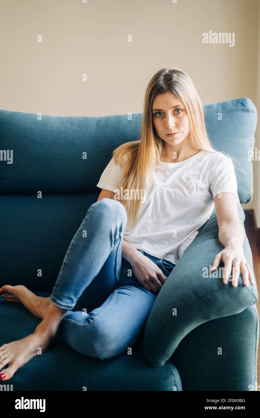 Full Body Of Calm Barefoot Female In Jeans Looking At Camera While