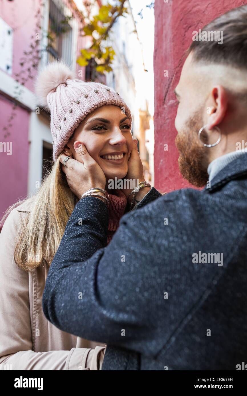 Side view of tender crop unrecognizable man embracing smiling charming ...
