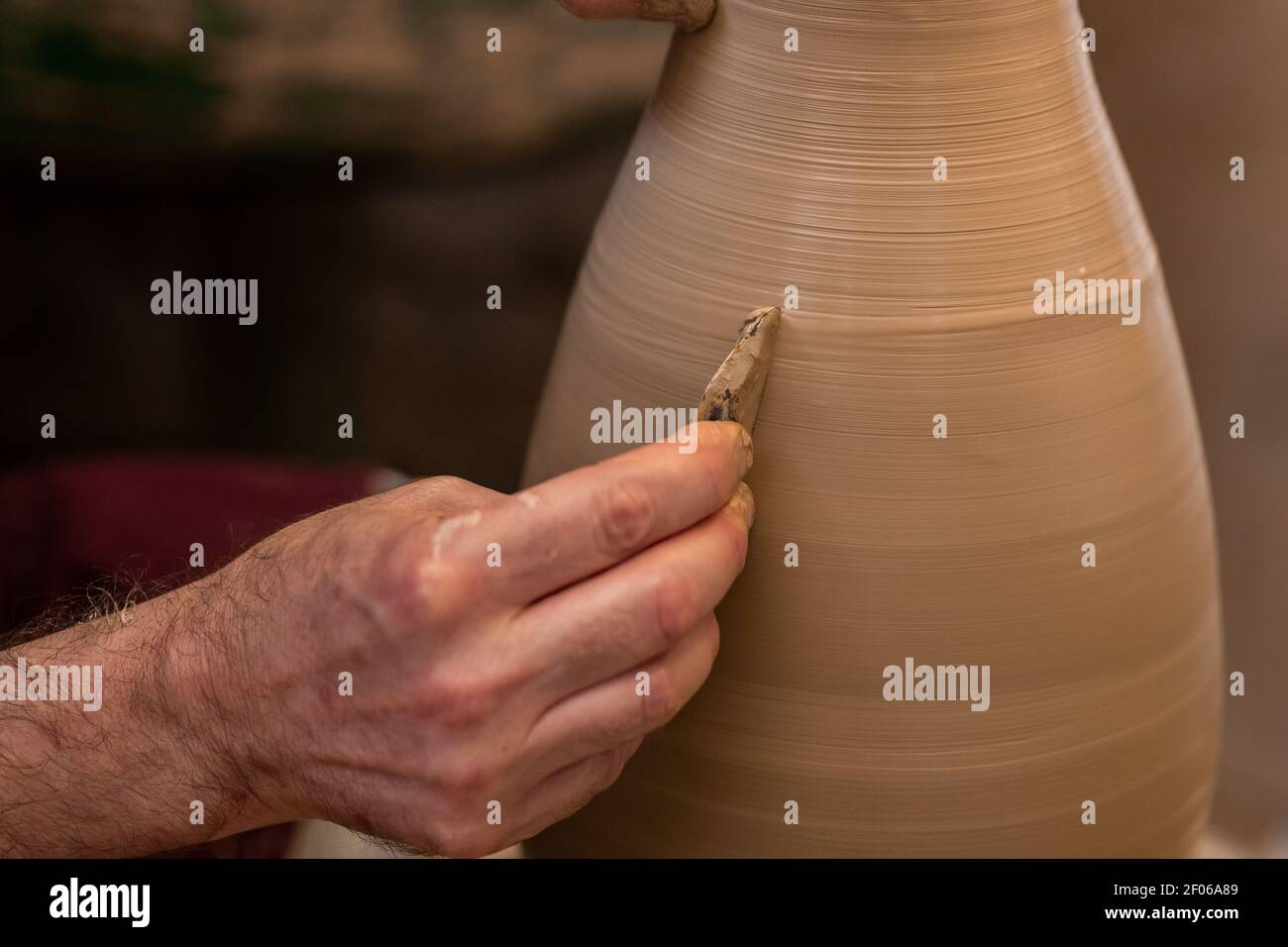 Crop unrecognizable sculptor with equipment giving shape while ...