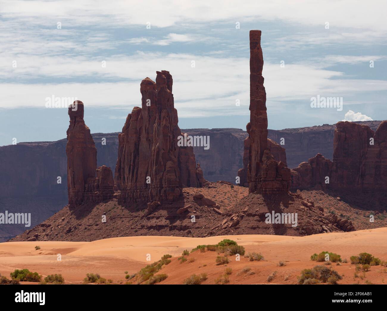 Amazing scenery of tall rocky monuments located in sunny desert sandy ...