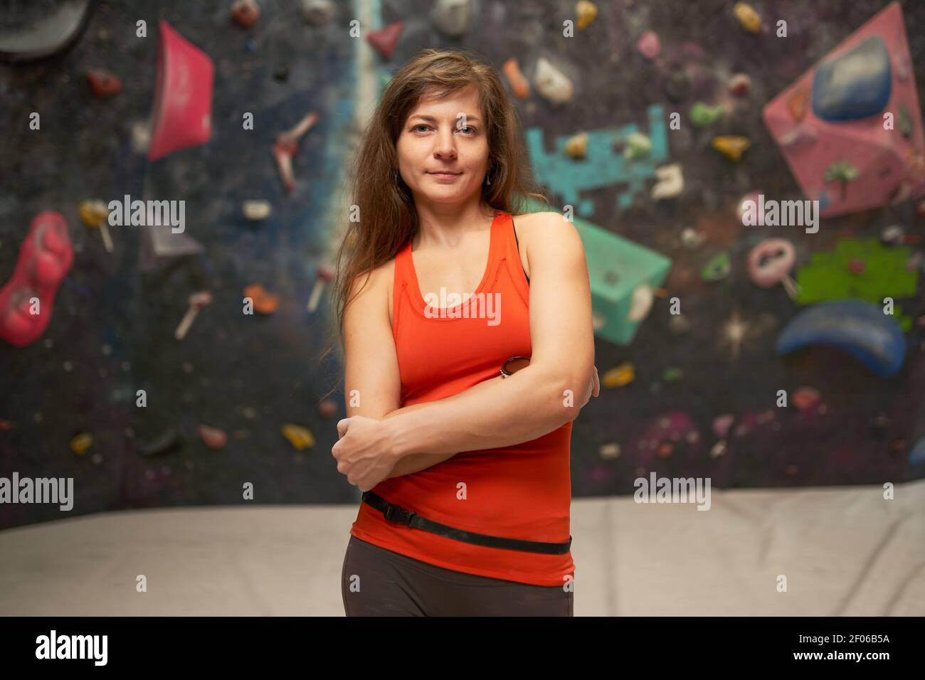 Charming strong Woman in sportswear with crossed arms standing near ...