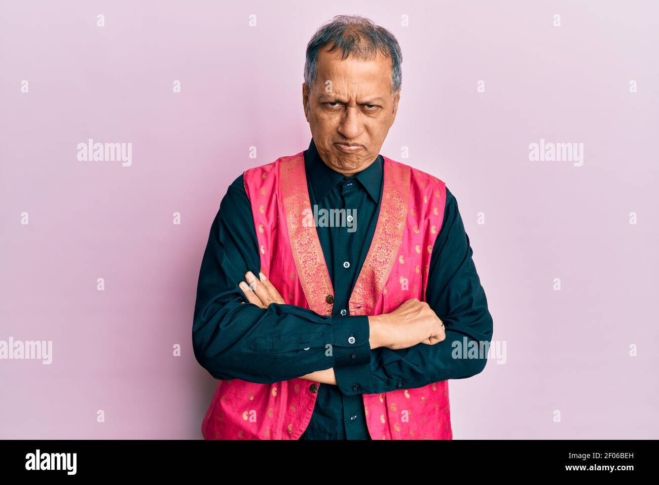 Middle age indian man wearing traditional indian clothes skeptic and ...