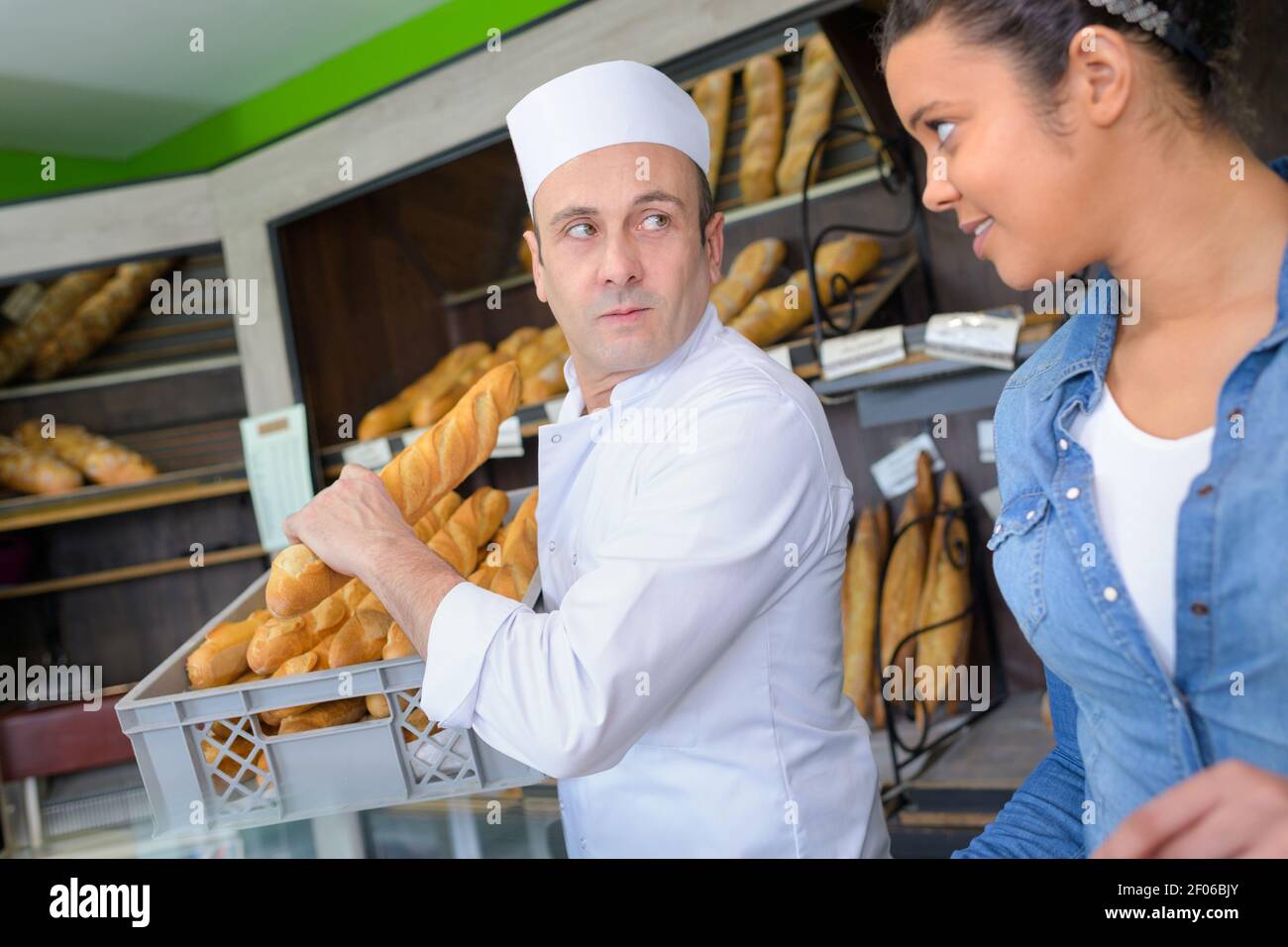 salesman and woman in bakery Stock Photo - Alamy