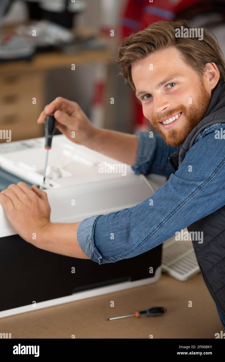 a man working on air conditioning unit flap open Stock Photo - Alamy