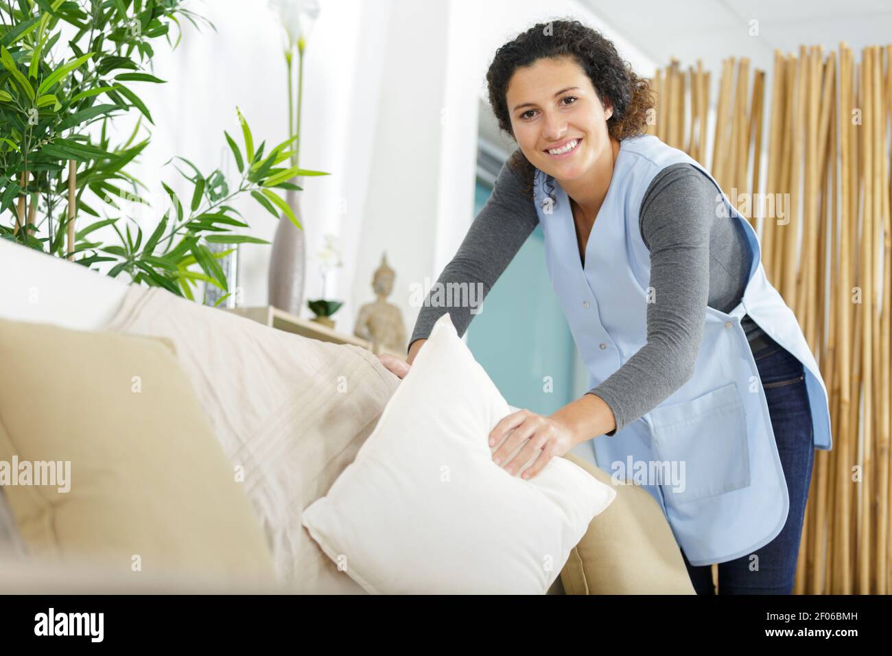 beautiful female housekeeper working in room Stock Photo - Alamy