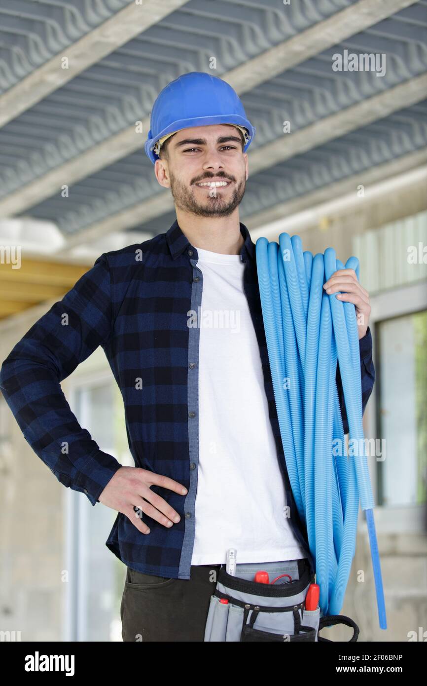 plumber with tool belt on white background Stock Photo - Alamy