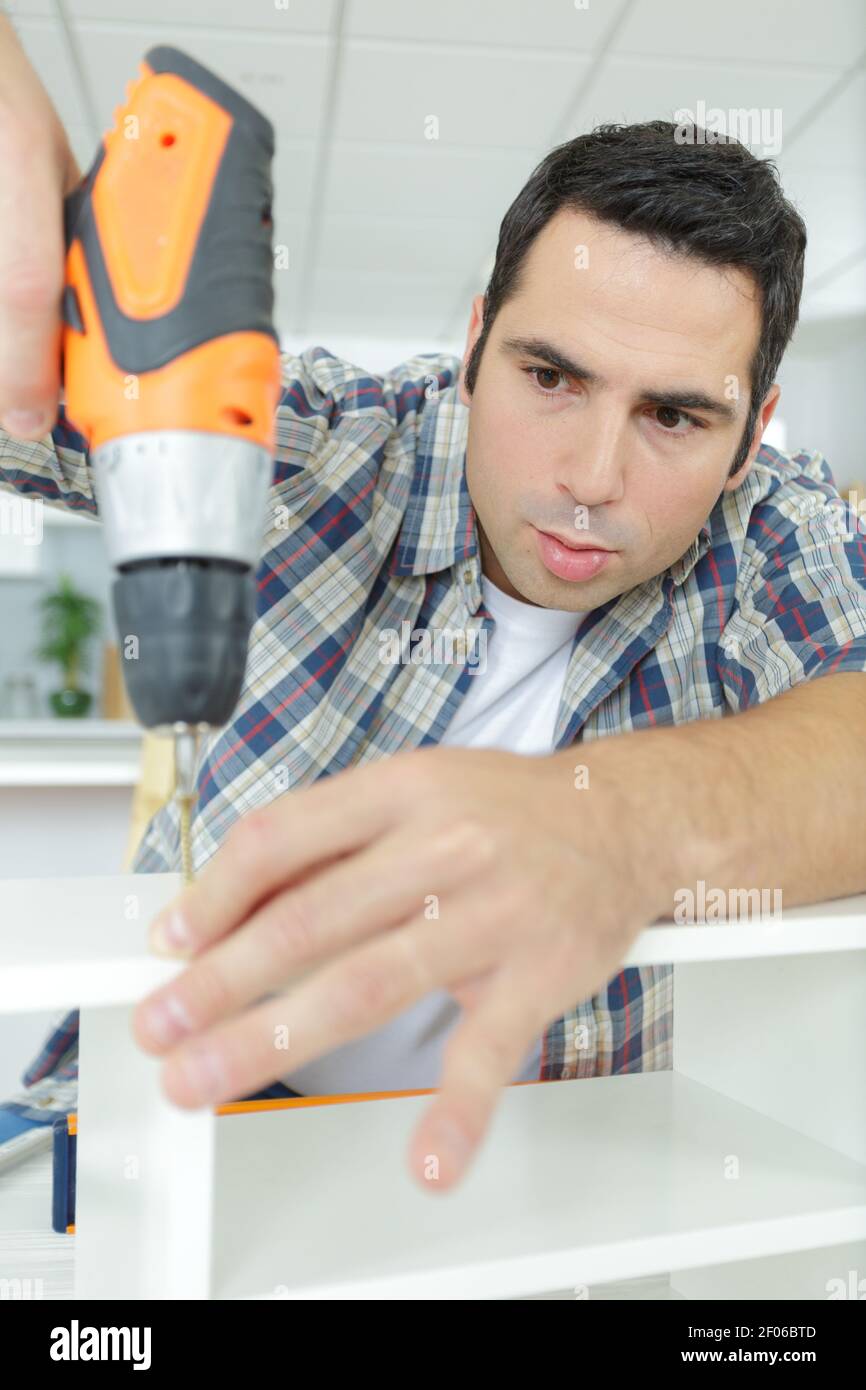 drilling the holes in furniture Stock Photo - Alamy