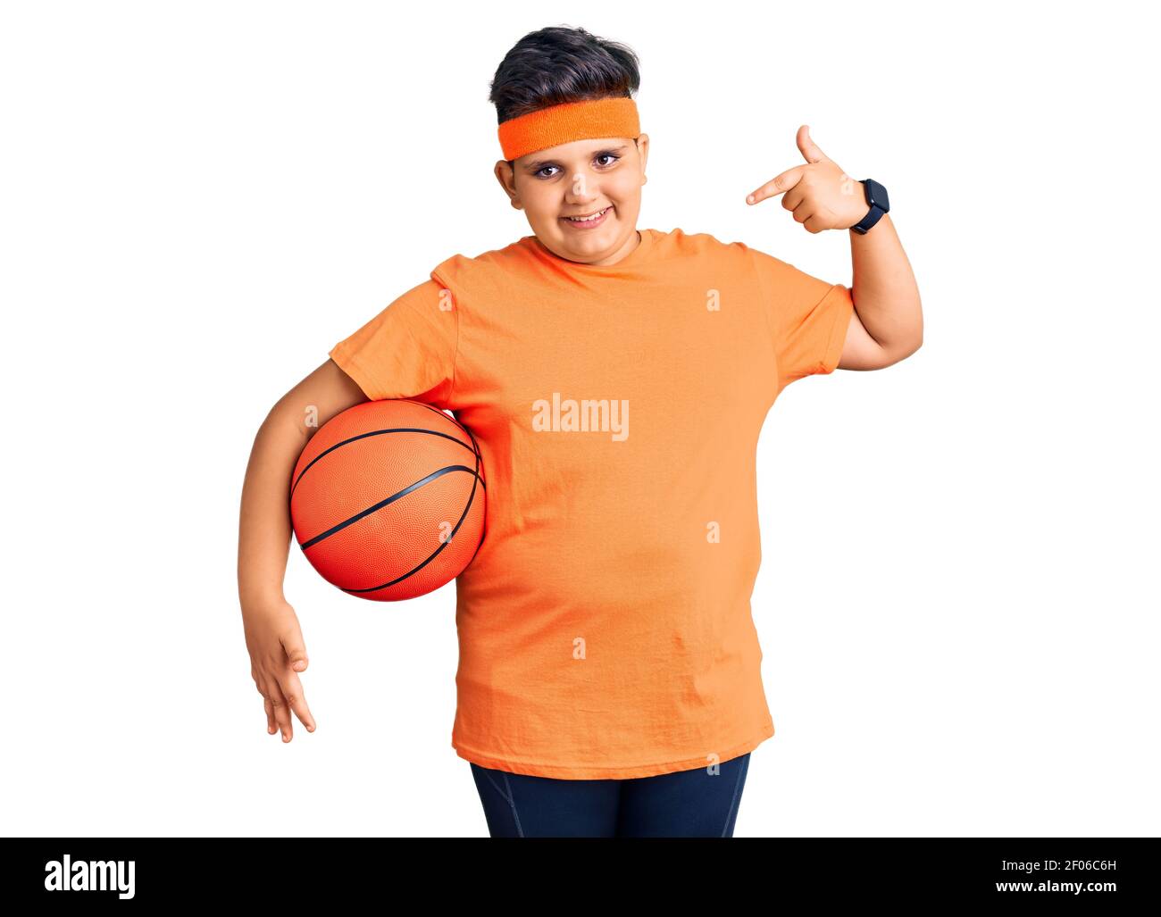 Little boy kid holding basketball ball pointing finger to one self ...