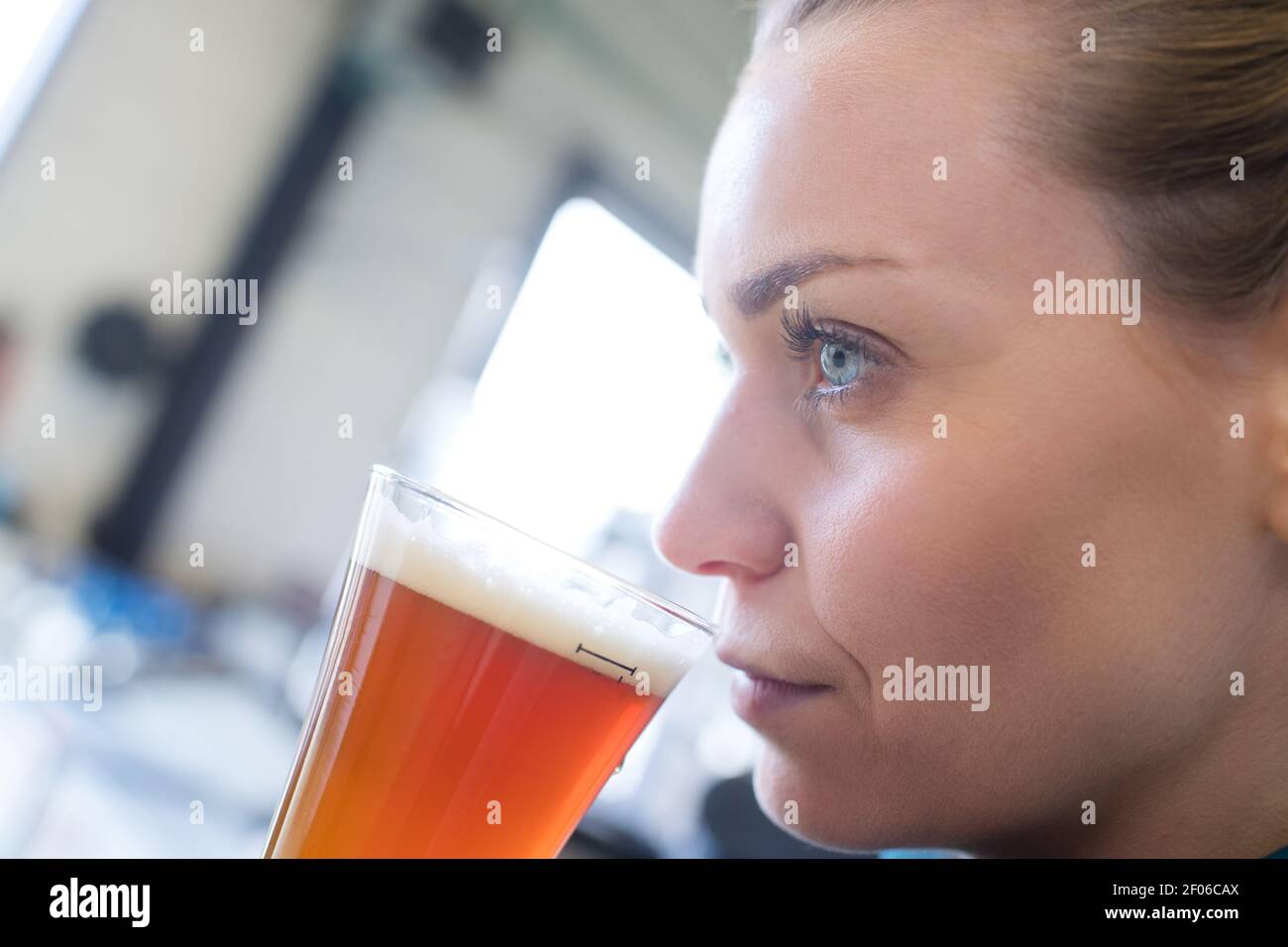 young female bartender tasting draft beer in bar Stock Photo - Alamy