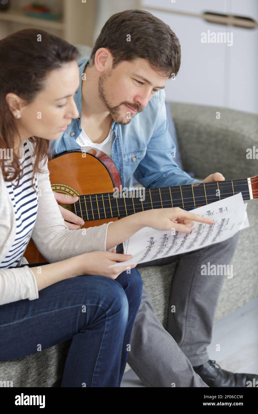 Teacher playing guitar with students hi-res stock photography and ...