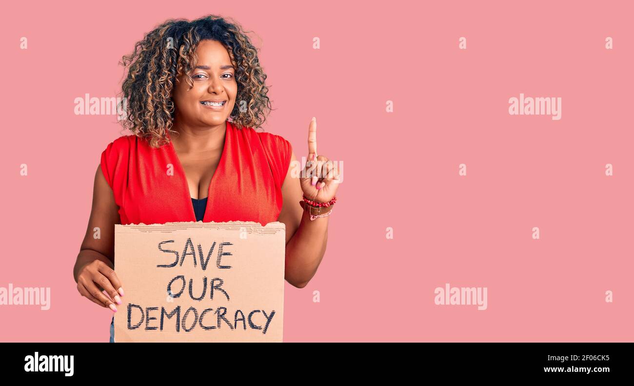 Young african american plus size woman holding save our democracy ...