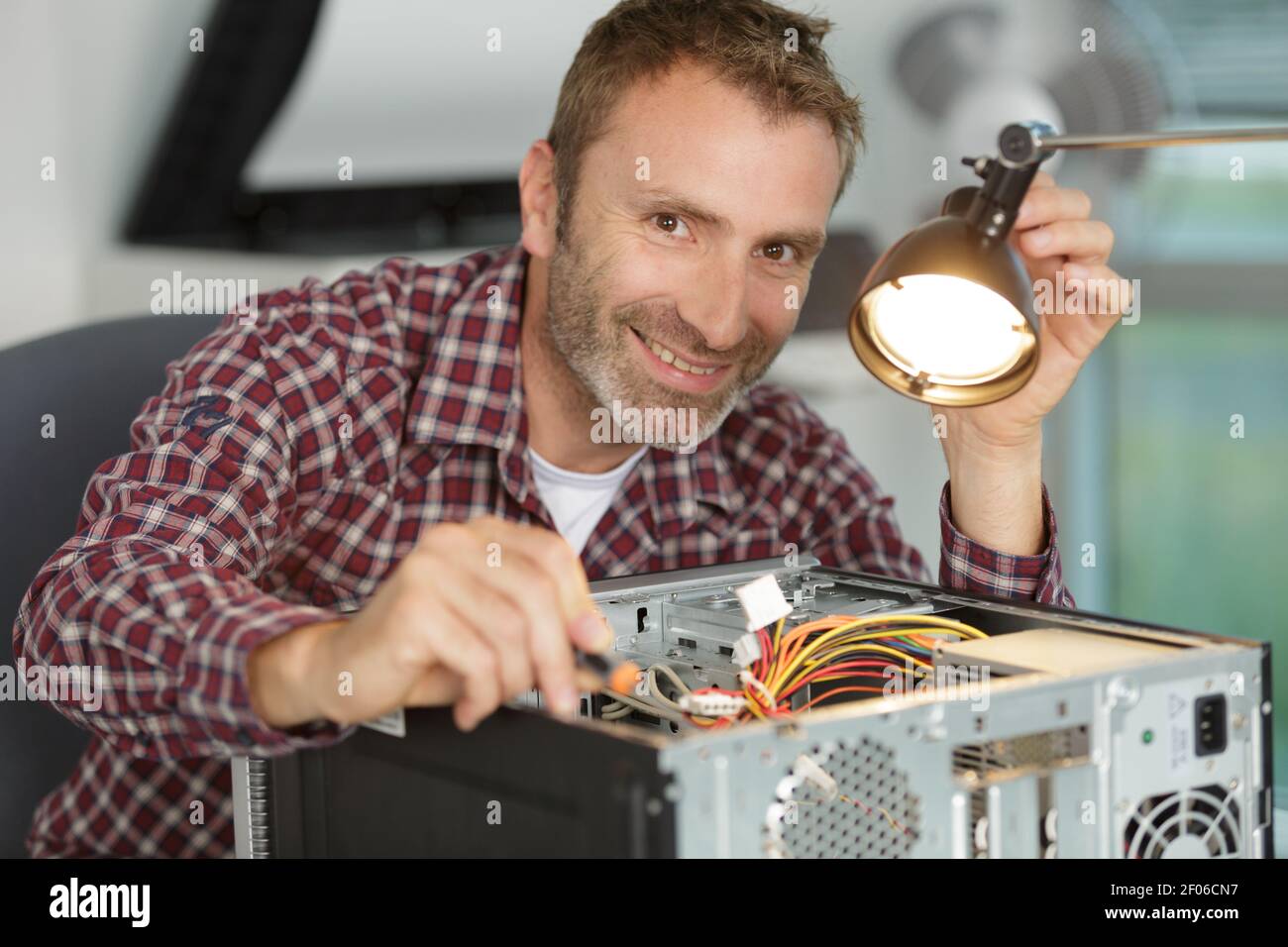 happy and smily man fixing computer Stock Photo - Alamy