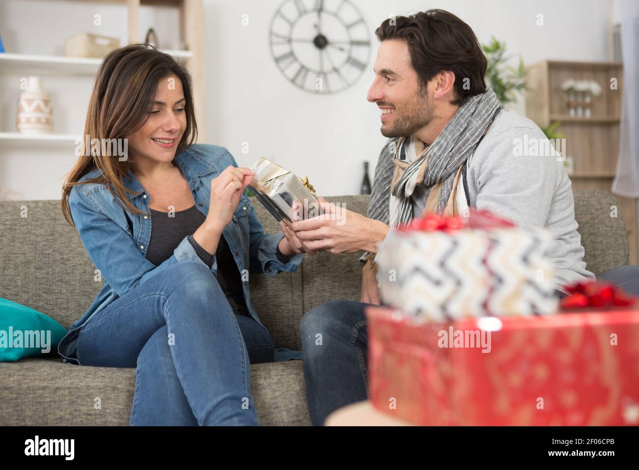 happy woman receiving a present from her husband Stock Photo - Alamy