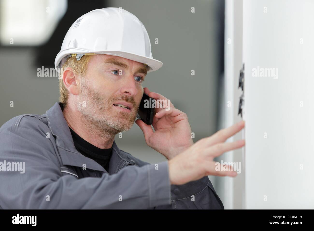 male tradesman making telephone call Stock Photo - Alamy