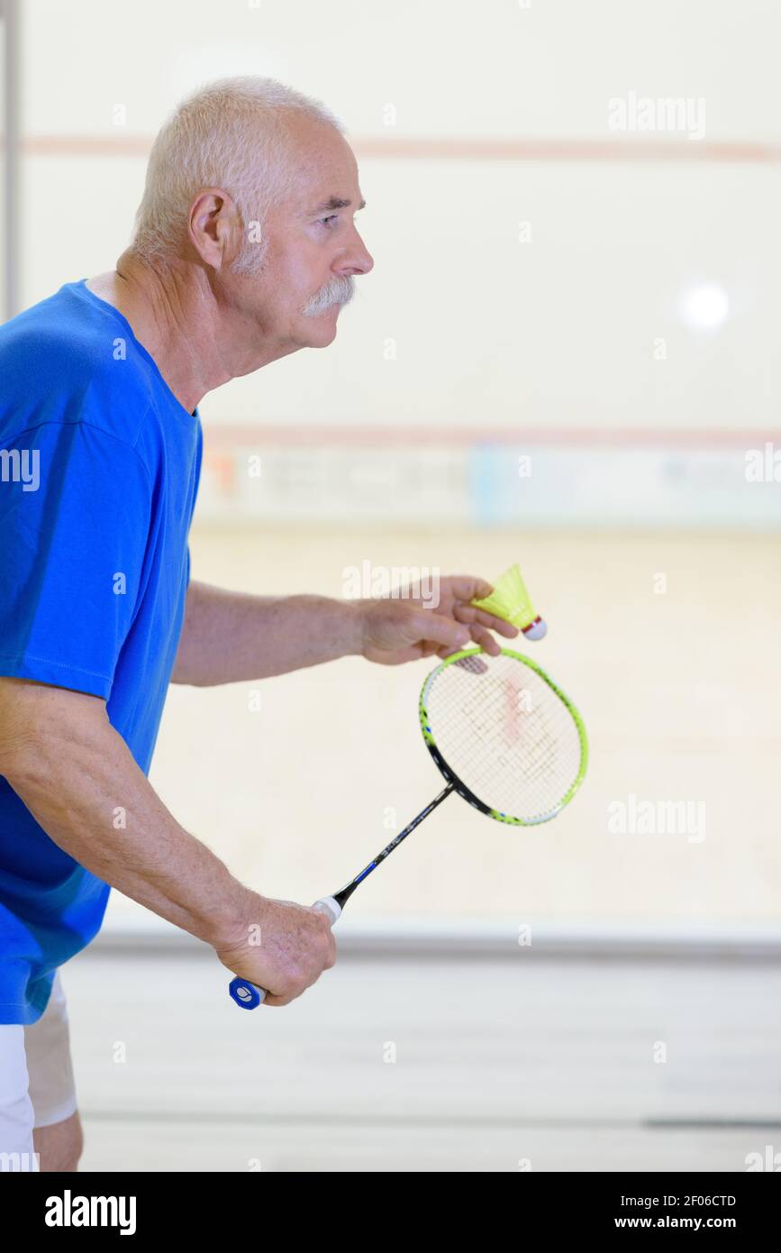 senior man playing badminton in court Stock Photo - Alamy