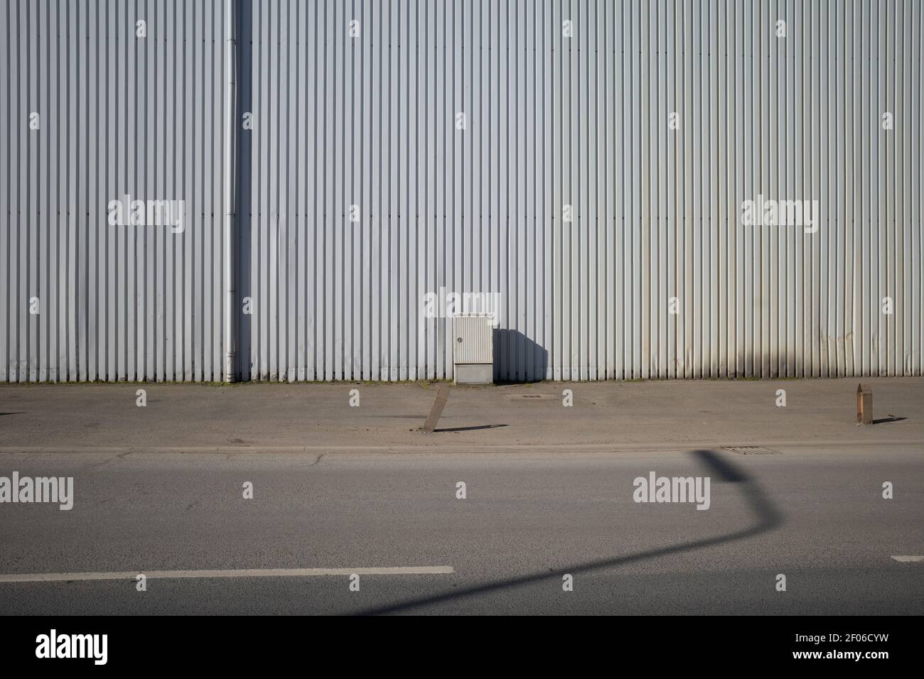 Outdoor exterior street view of sidewalk and white vertical aluminium ...