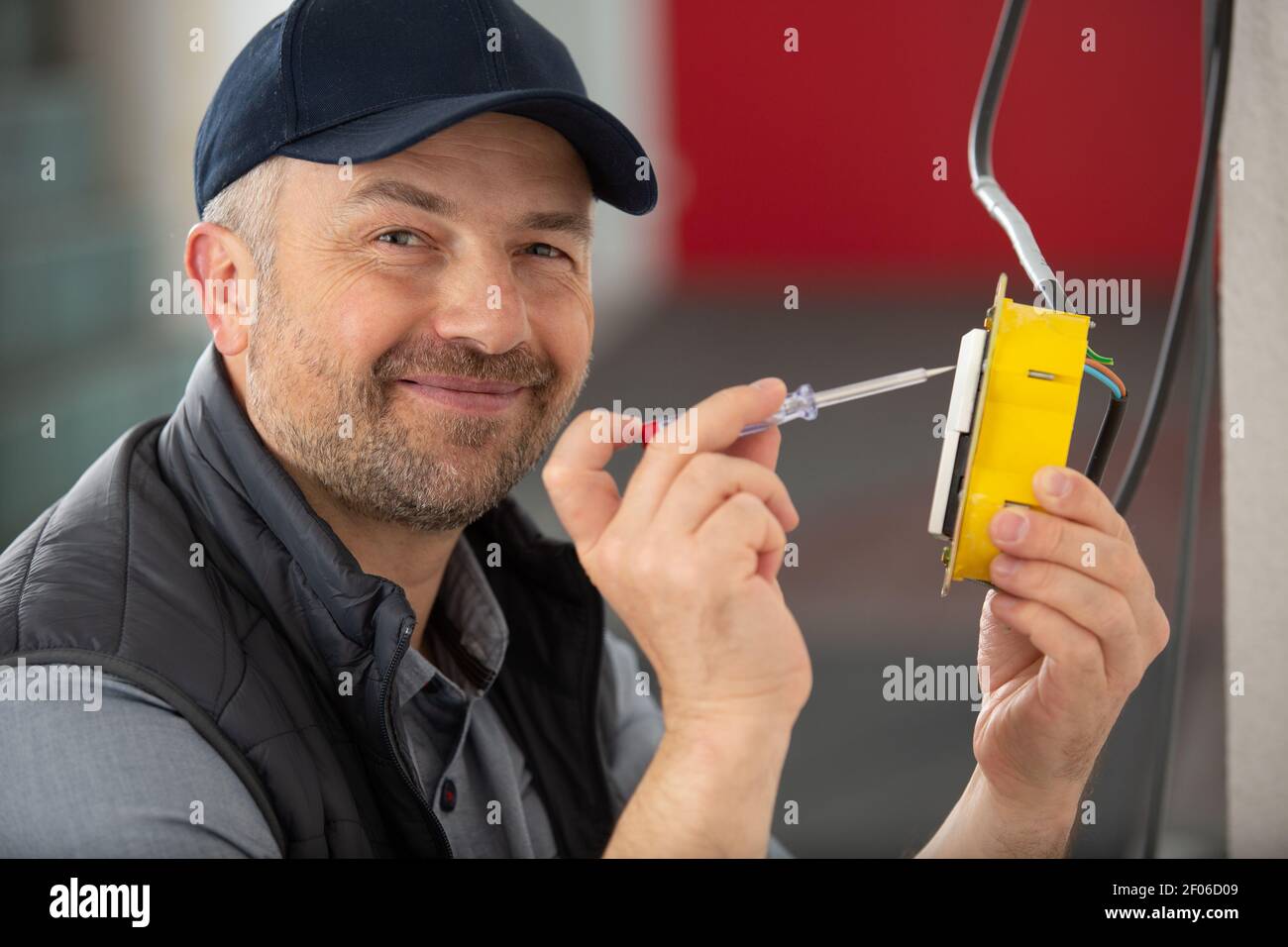 electrician checking wiring on electrical switch Stock Photo - Alamy