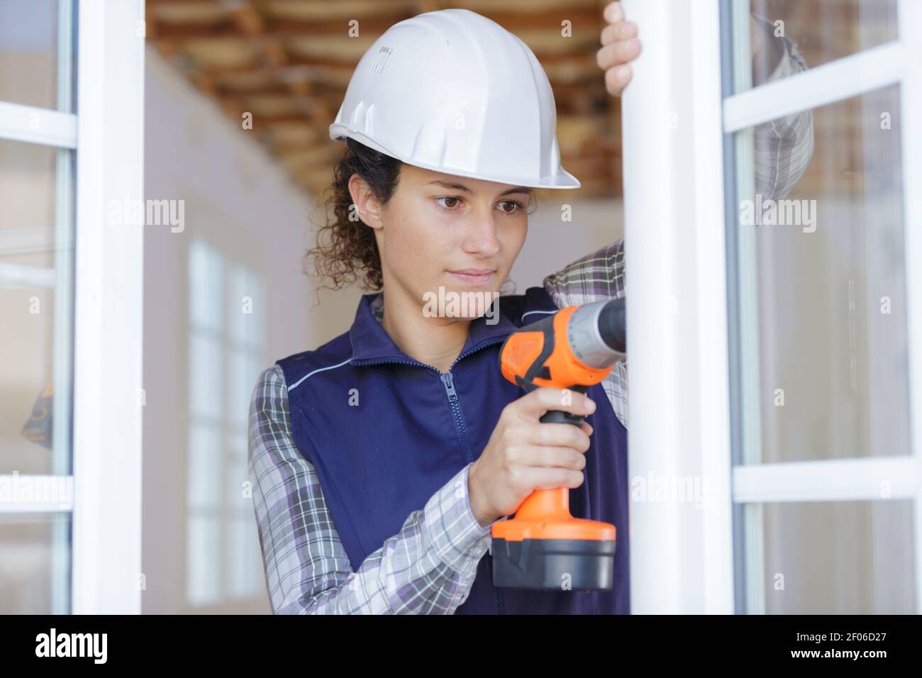 construction worker drilling a window Stock Photo - Alamy