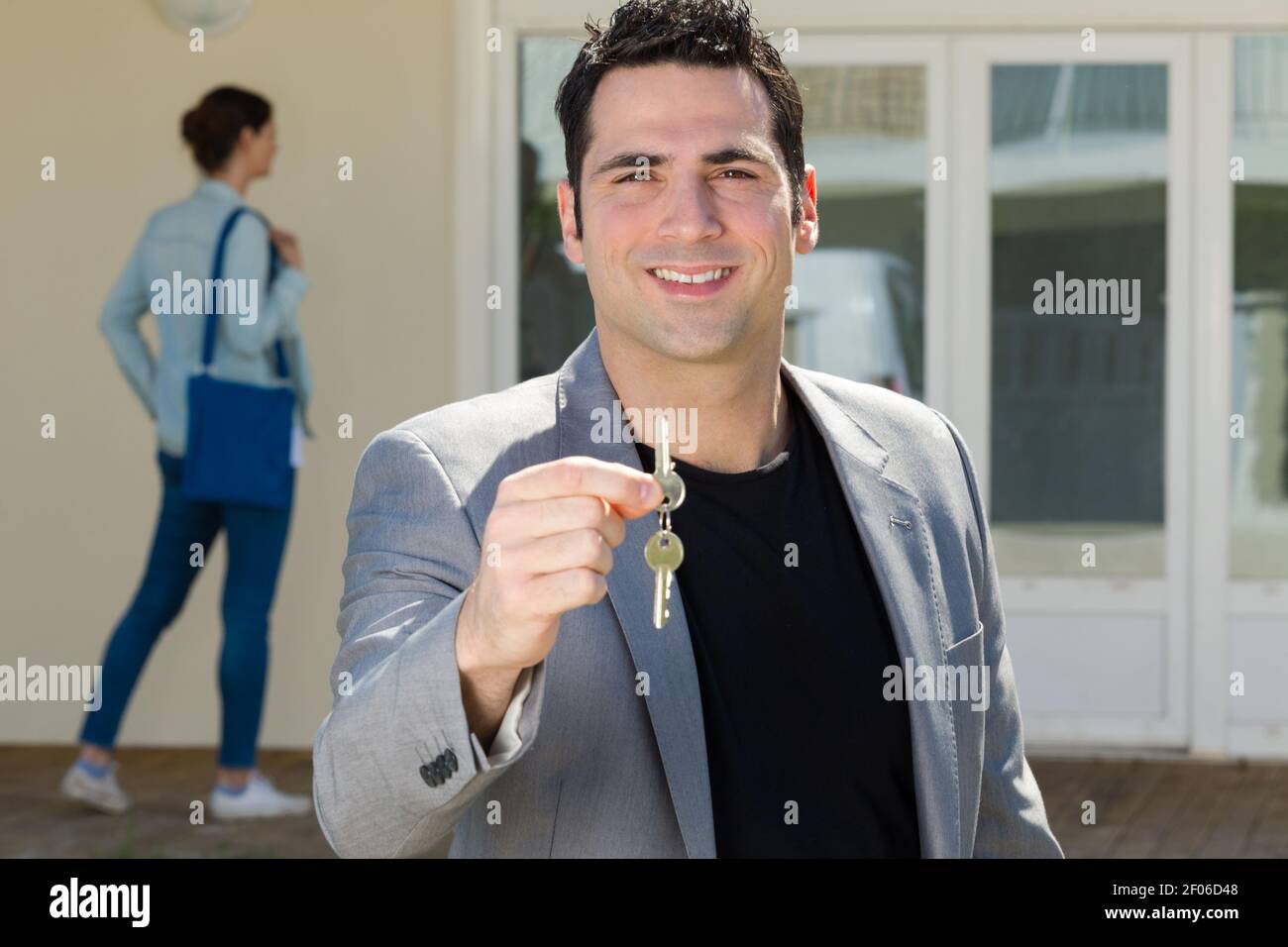 man showing the key of a house Stock Photo - Alamy