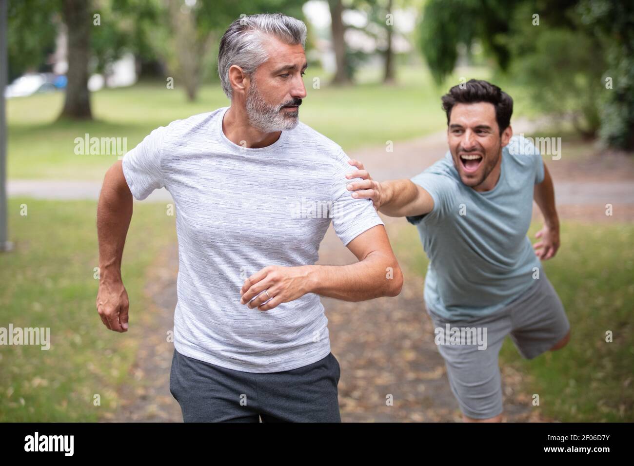 two men running in park Stock Photo - Alamy