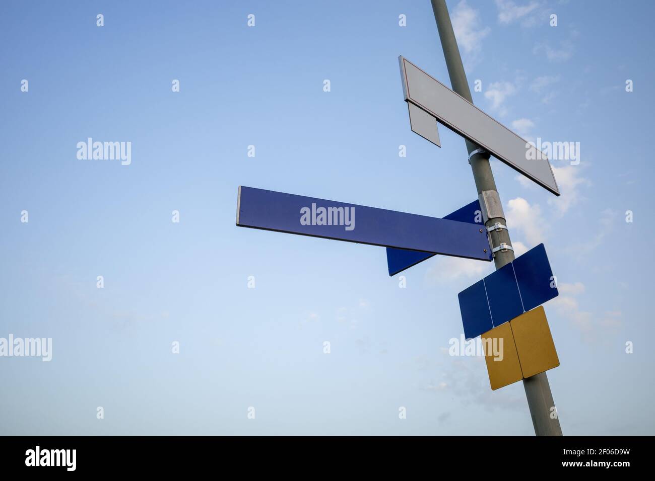 Empty road direction sign against sunny blue sky Stock Photo - Alamy