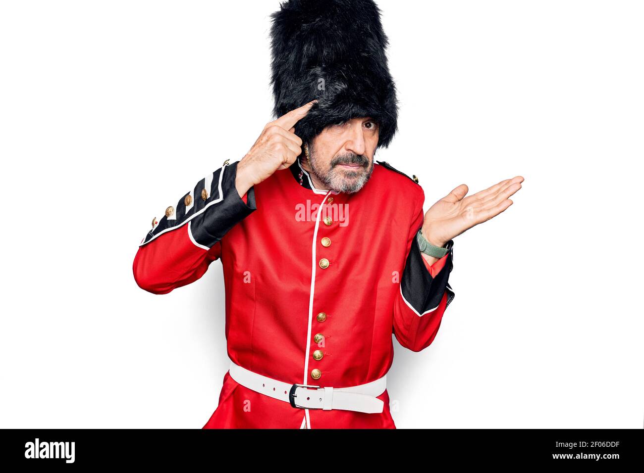 Middle age handsome wales guard man wearing traditional uniform over ...