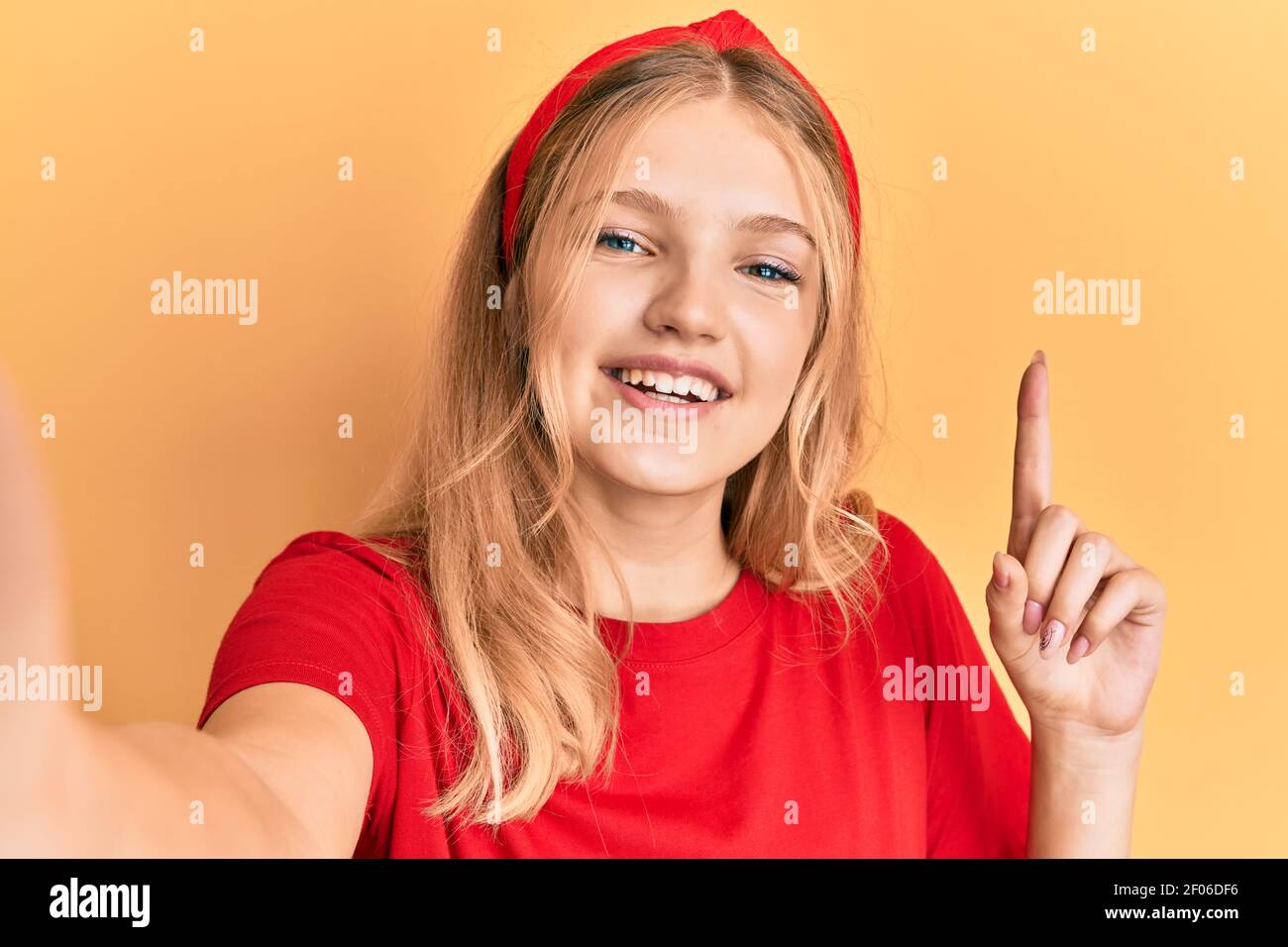 Beautiful young caucasian girl taking a selfie photo smiling with an ...