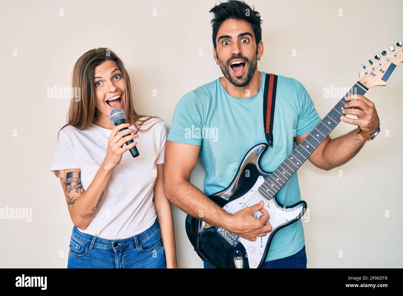 Beautiful young couple of boyfriend and girlfriend singing song using ...