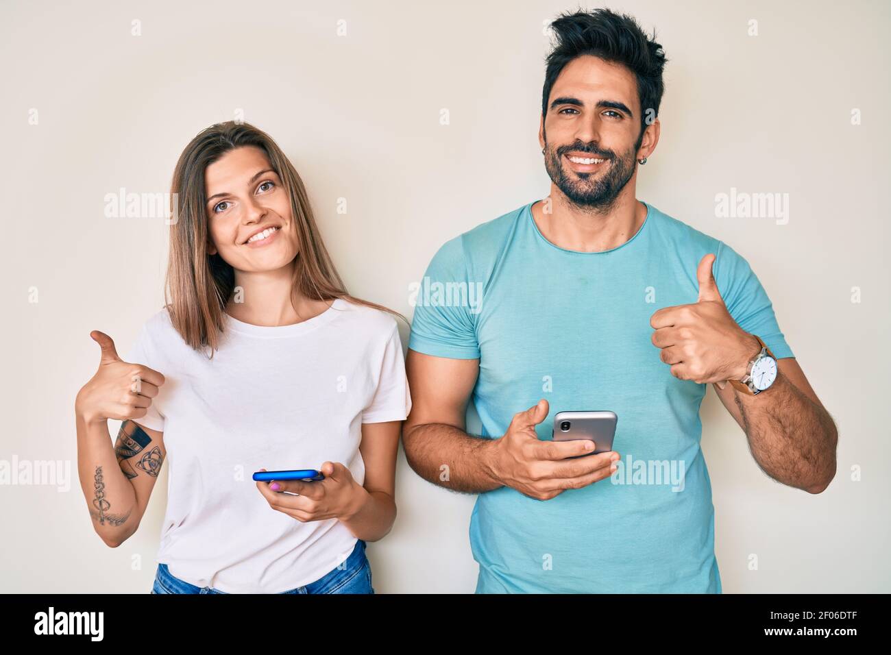 Beautiful young couple of boyfriend and girlfriend using smartphone ...