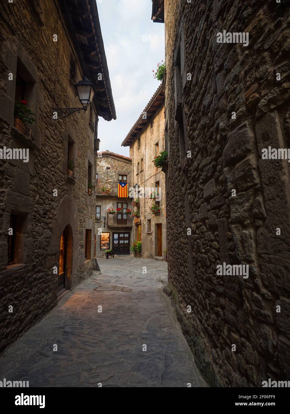 Medieval architecture stone rock buildings flower Senyera flag in ...