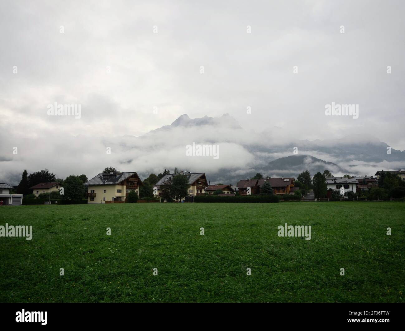 Alpine mountain panorama view in town village of Saalfelden at green ...