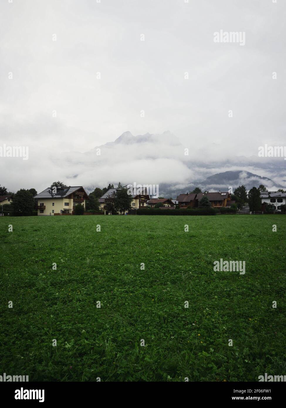 Alpine mountain panorama view in town village of Saalfelden at green ...