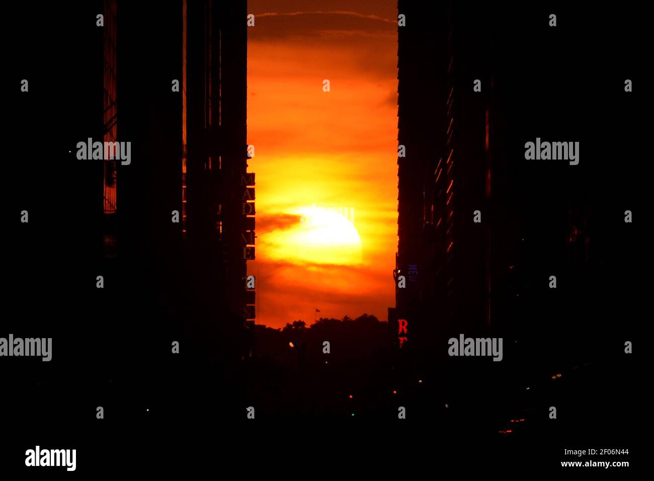 The sun sets as seen from 42nd street and First Avenue during ...