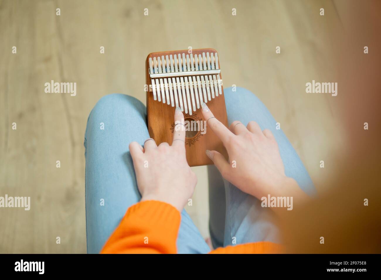 women's hands play music on African musical instrument kalimba Stock ...