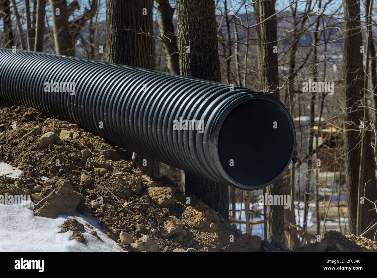 Plastic main black pipes on heap of polyethylene pipes for a drain ...
