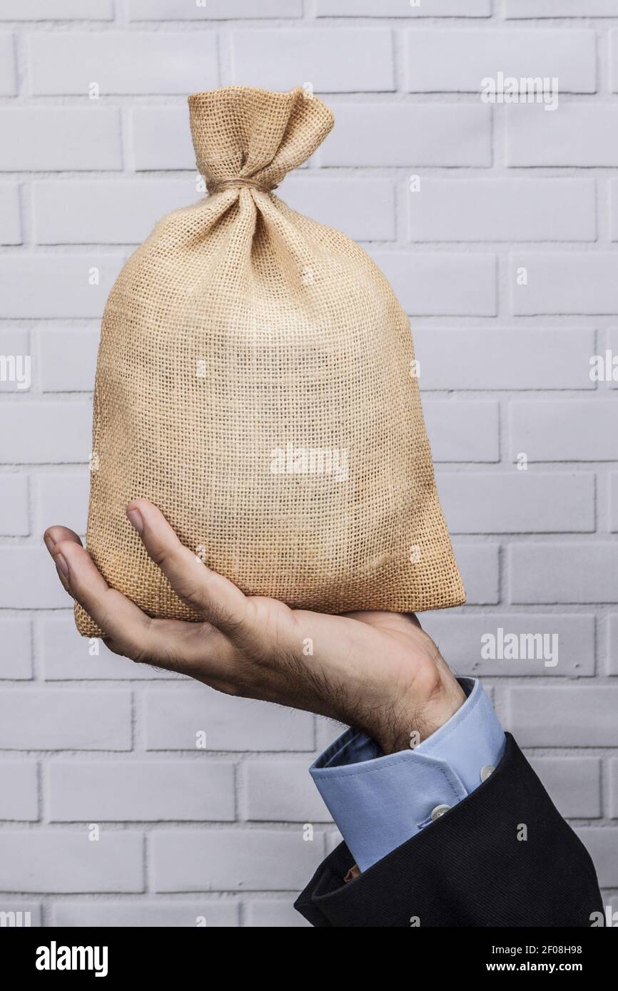 Money Sack In Hand Stock Photo - Alamy