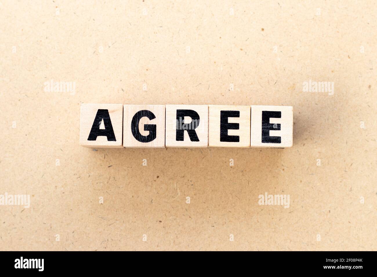 Letter block in word agree on wood background Stock Photo - Alamy