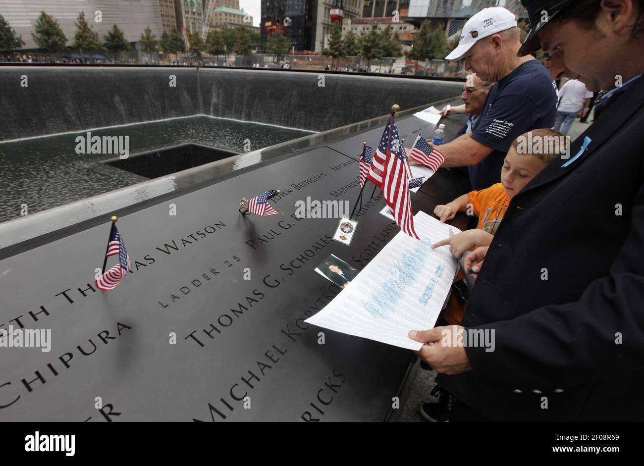 11 September 2011 - New York, NY - Mourner etch the names of a lost ...