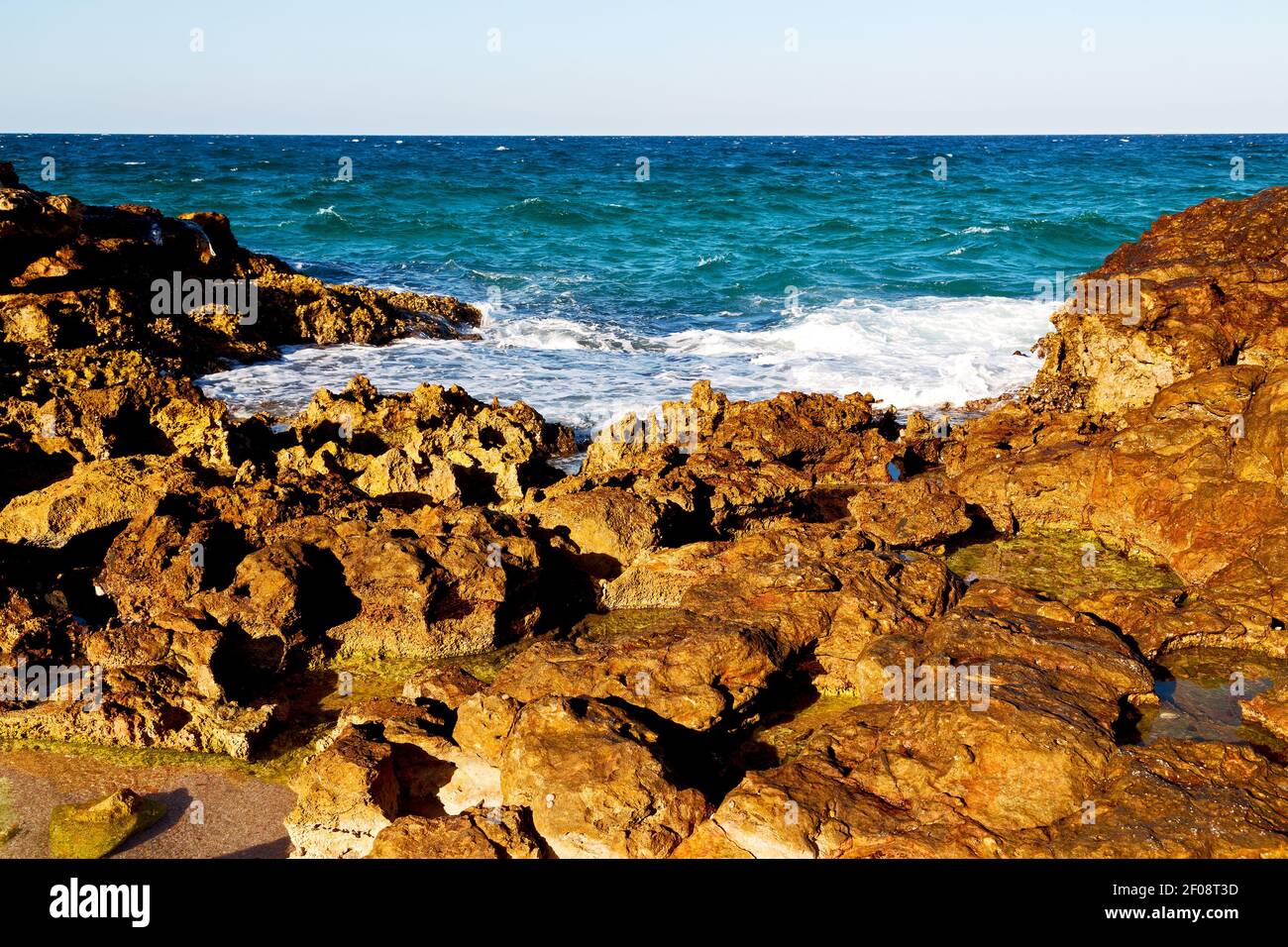 In oman ocean gulf rock Stock Photo - Alamy