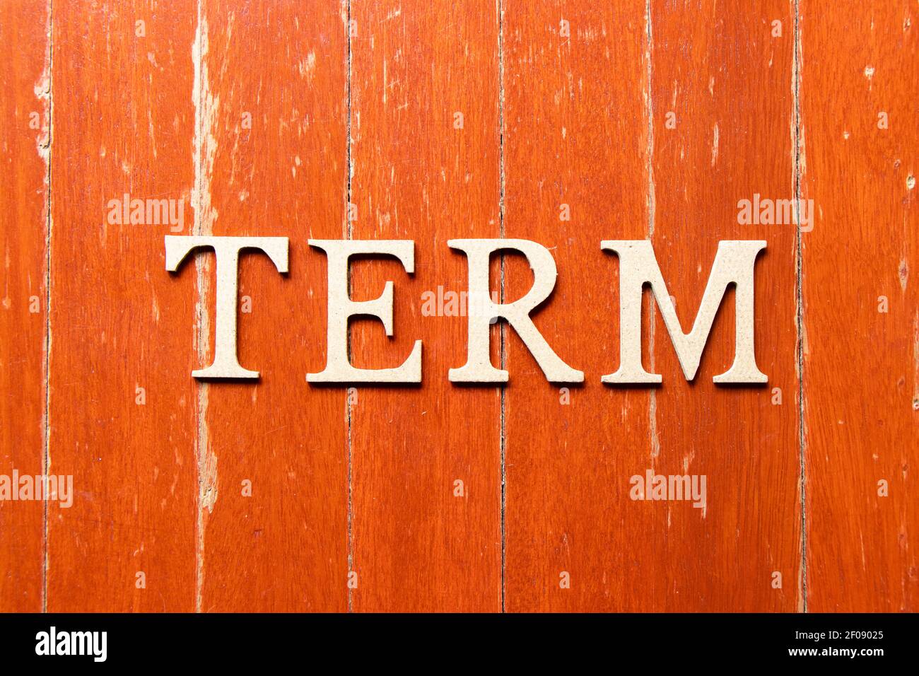 Alphabet letter in word term on old red color wood plate background ...
