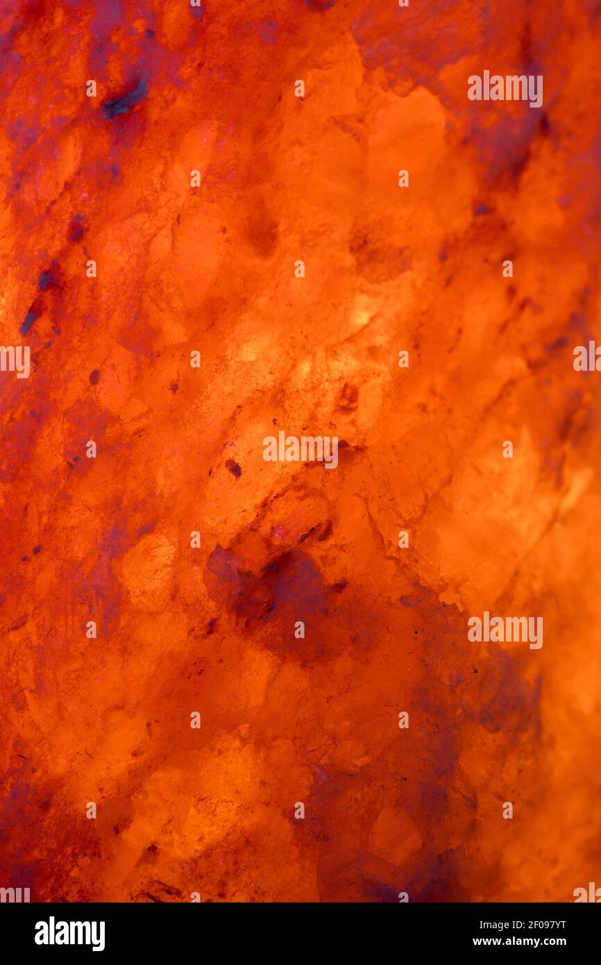 Bright orange salt lamp rock background texture Stock Photo - Alamy