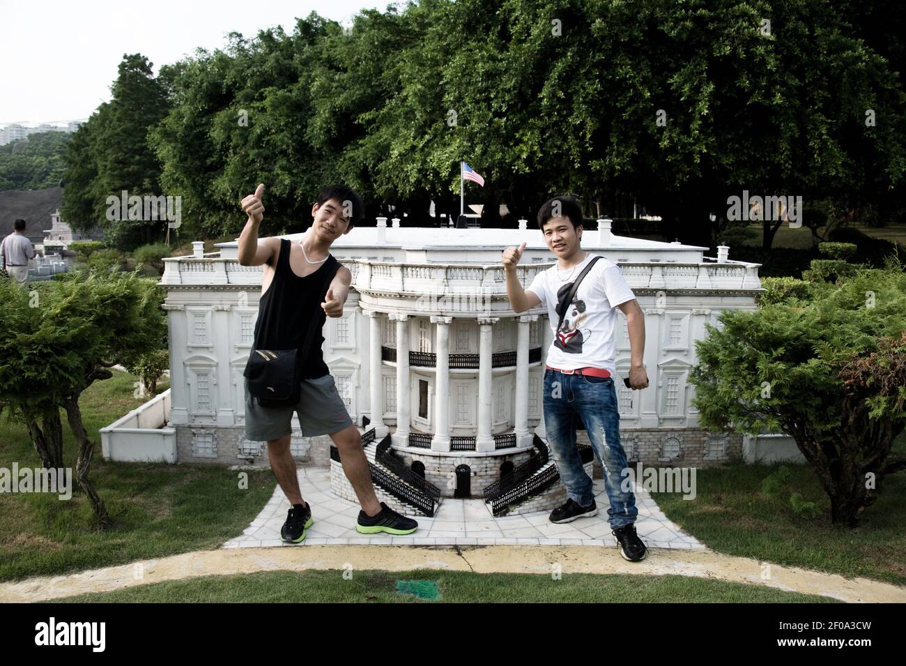 Two young Chinese in front of White House replica. (Photo by Raphael ...