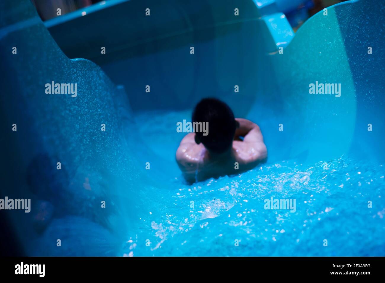 A young boy inside a water slide at the Magic Water Park in Beijing ...