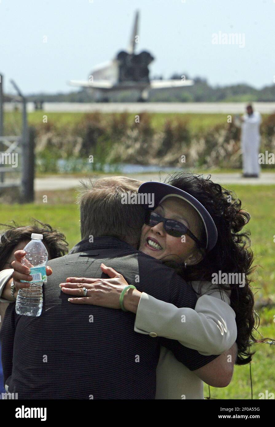 Kennedy space Center workers hug Wednesday, March 9, 2011 as space ...