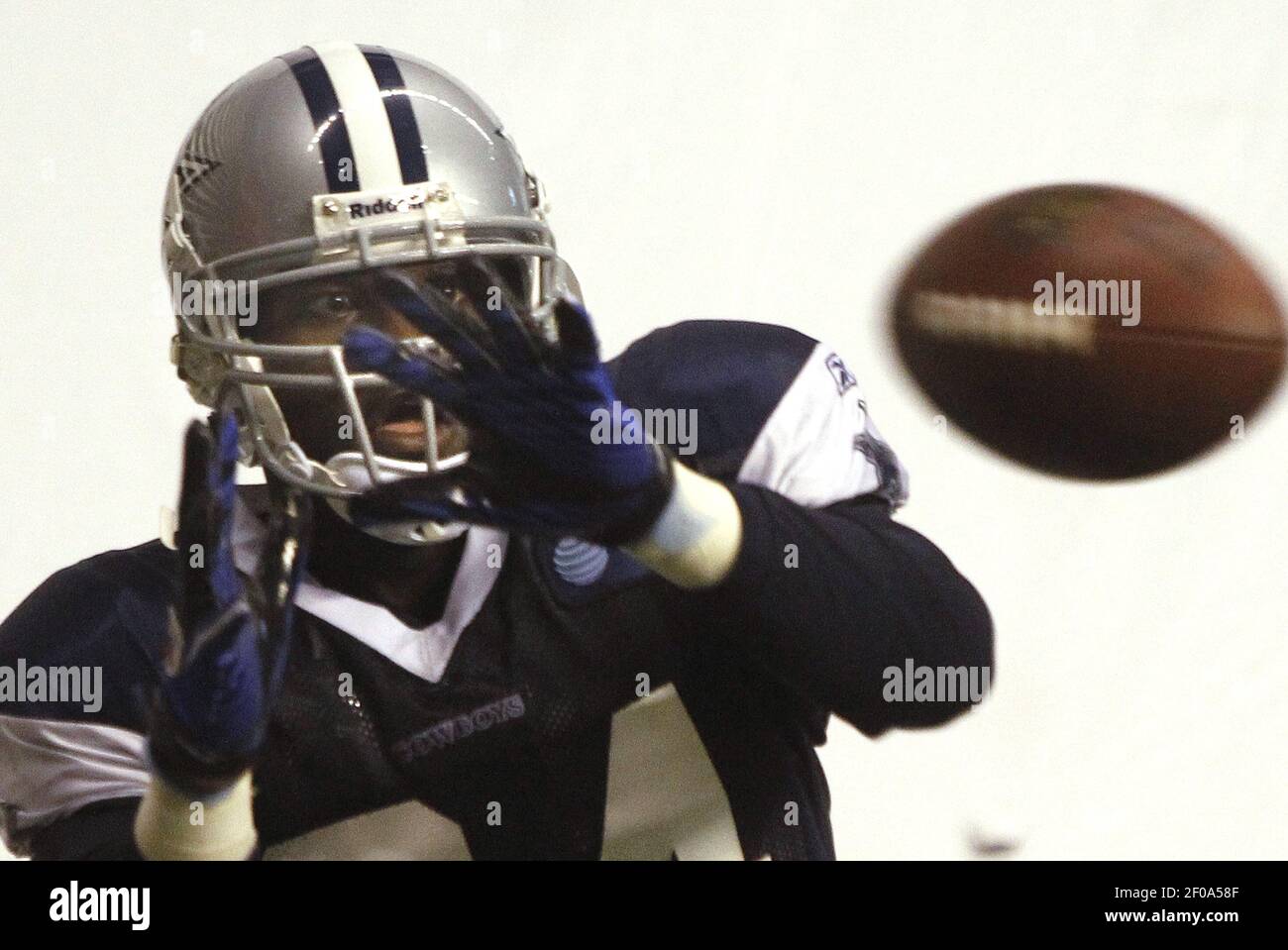 Dallas Cowboys safety Abe Elam pulls in the ball during a passing drill ...