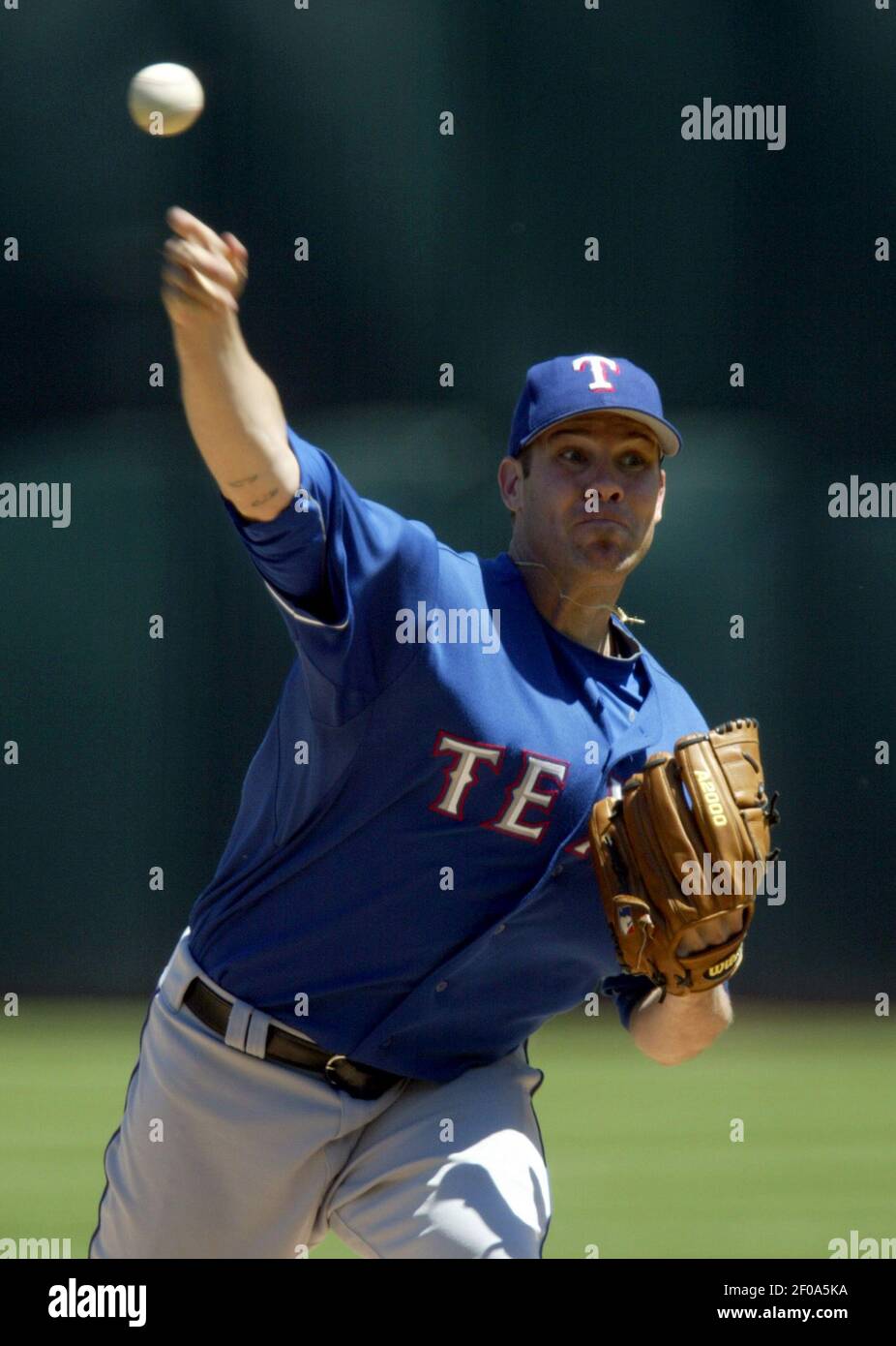 Texas Rangers pitcher Colby Lewis throws in the first inning against ...